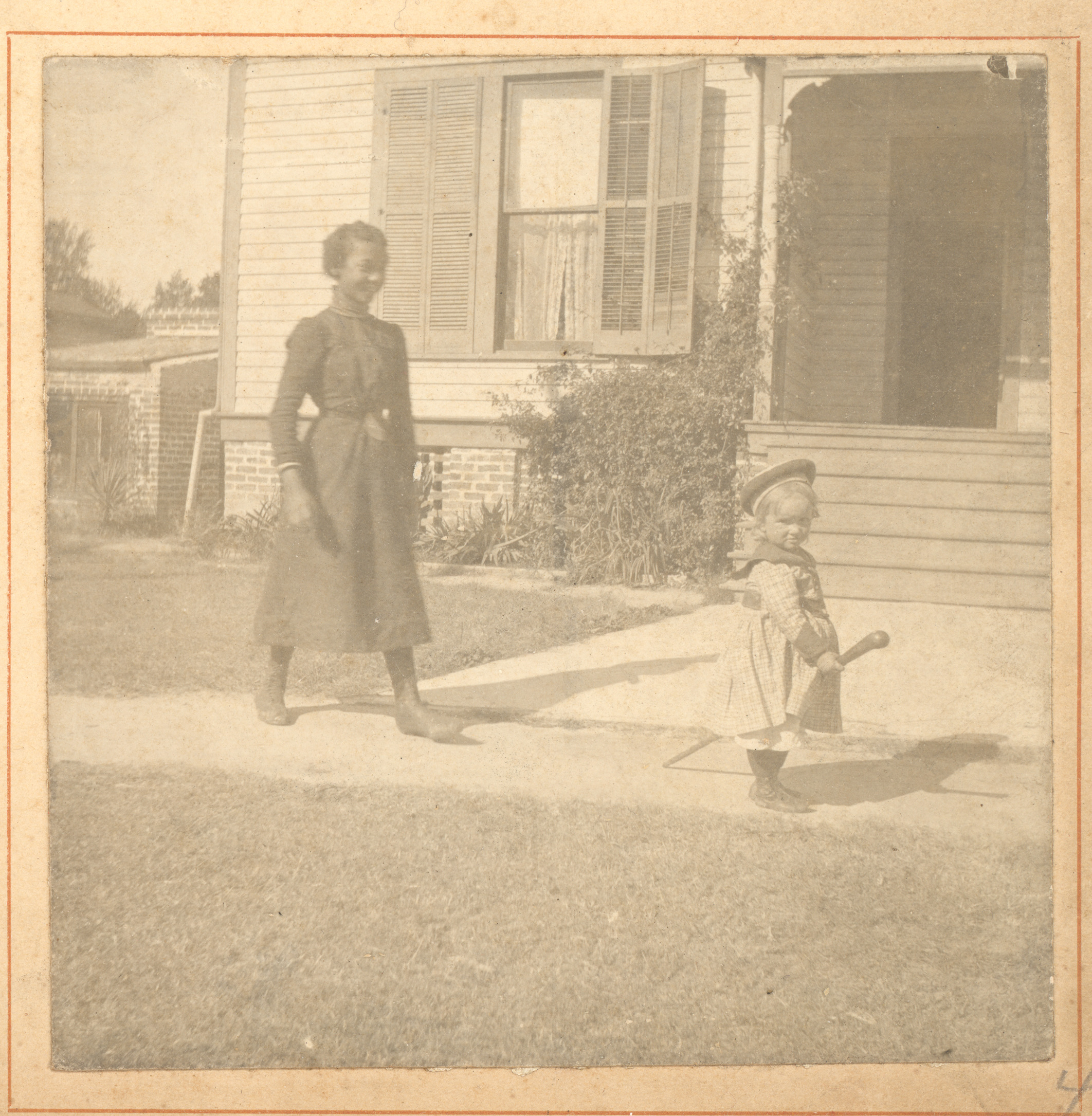 Child with Cane Followed by Young Adult
