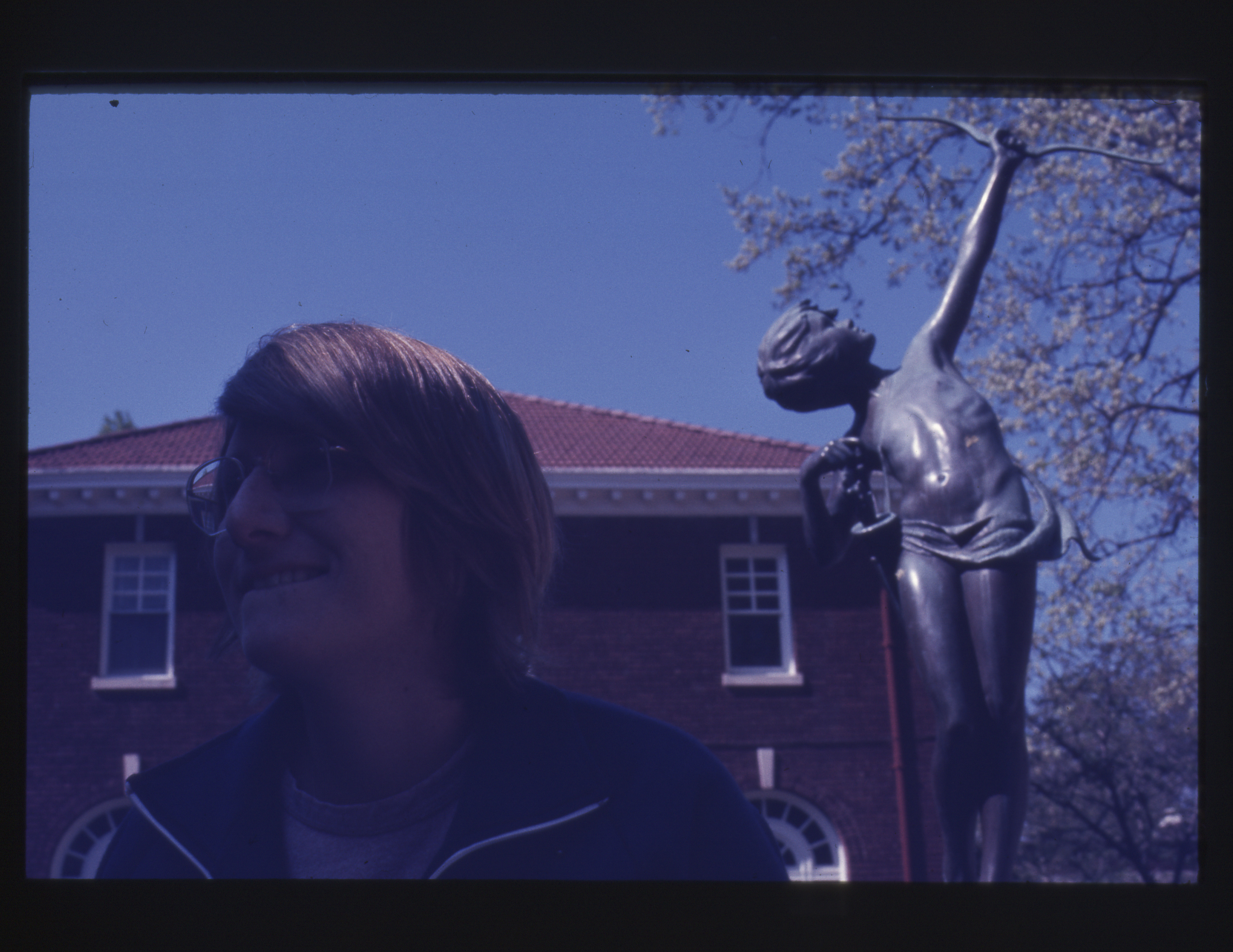 Queens College Student Posing with Statue
